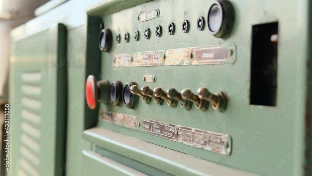 old electrical panel in abandoned factory with red button and shiny ...