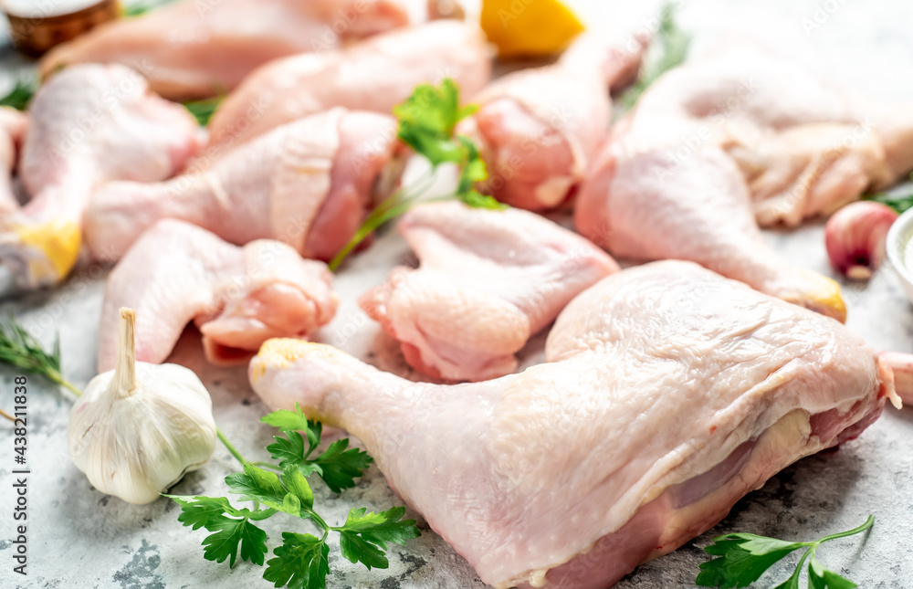 Different parts of chicken for barbecue with breast, legs and wings on ...