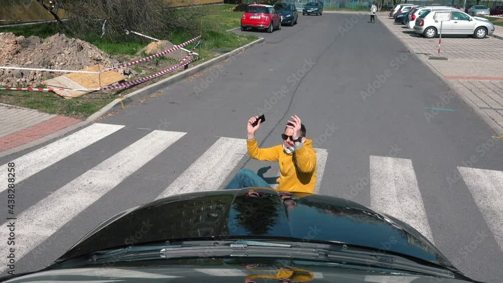 Fall of a pedestrian at a crosswalk. The car hits a man. The man takes photographs of the car ...
