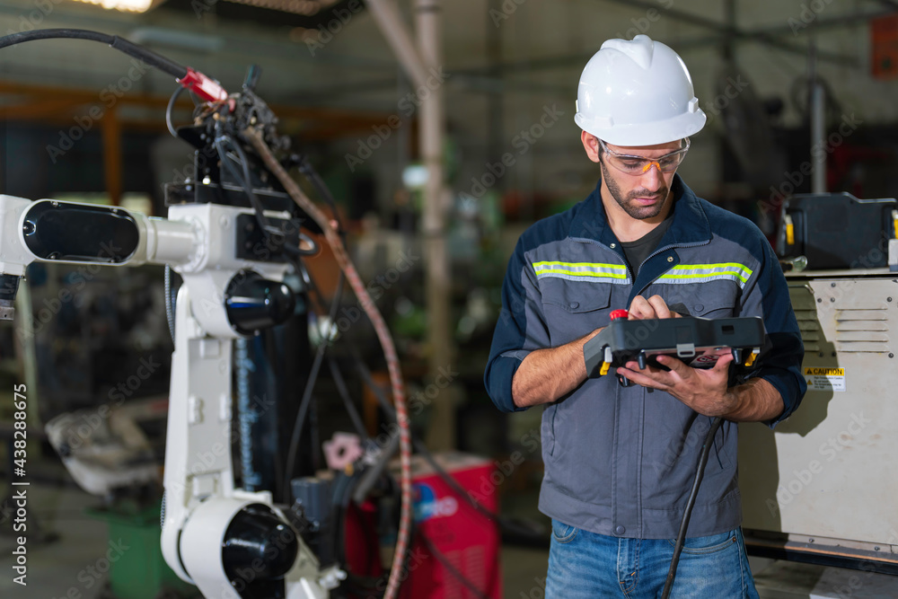 Portrait shot of mechanical engineer holding the robotic arms ...