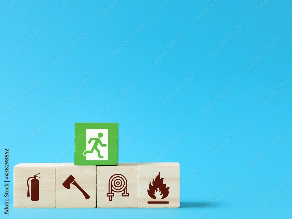 Wooden blocks with fire safety exit icons isolated on blue background ...