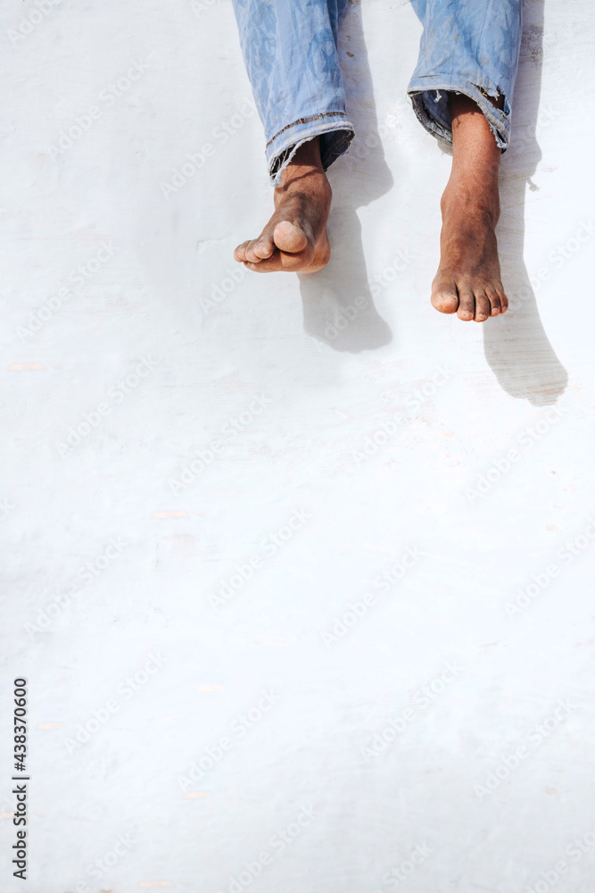 Legs of black child on white wall Stock Photo | Adobe Stock