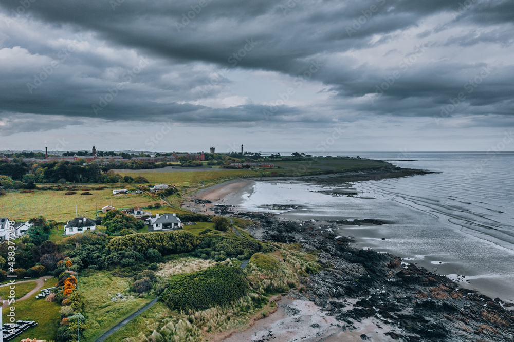 Old brick Quay buildings, the Portrane Round Tower, and Irish landscape ...