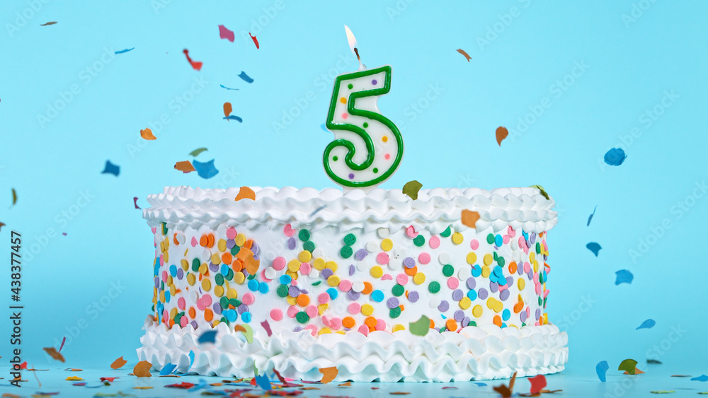 Colorful tasty birthday cake with candles shaped like the number 5 ...