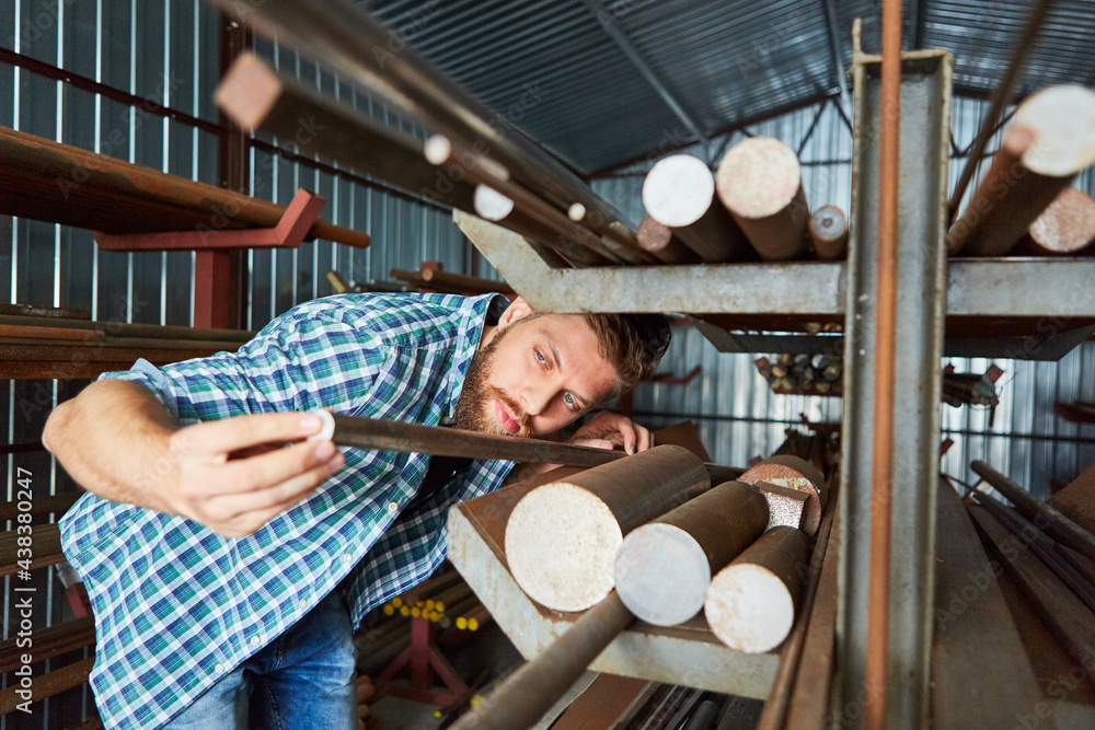 Warehouse clerk controls quality in the factory's material warehouse ...