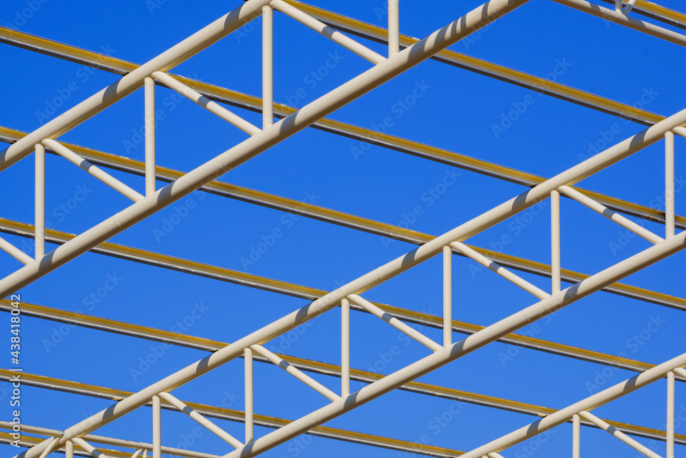 Low angle and diagonal view of yellow metal building roof structure in ...