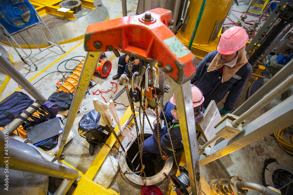 Top view male climb up the stairs into the tank stainless chemical area ...