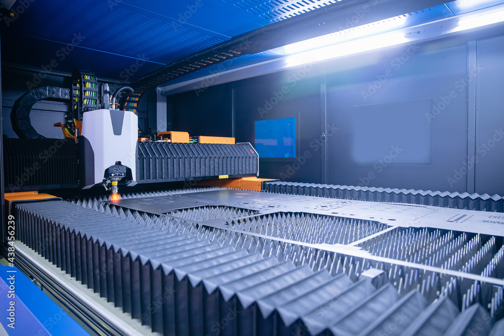 Industrial background CNC laser machine cutting sheet metal with light ...
