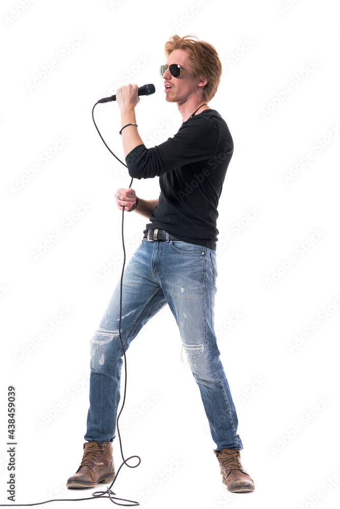 Passionate rock music singer singing loud on microphone with energy ...