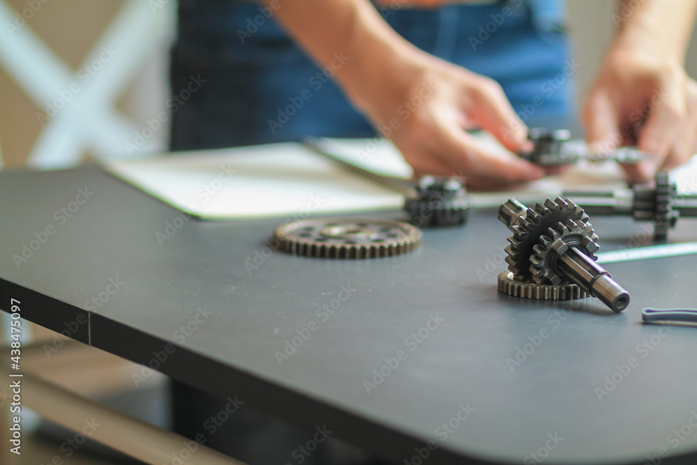 The gear set is placed on the workbench of a team of factory mechanical ...