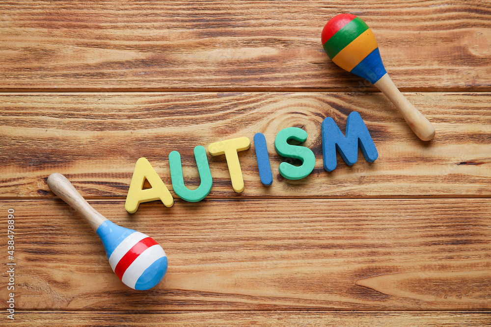 Word AUTISM and maracas on wooden background Stock Photo | Adobe Stock