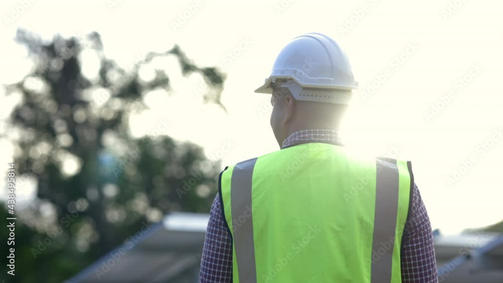 Back view Young asian electrical engineer standing in front of Solar ...