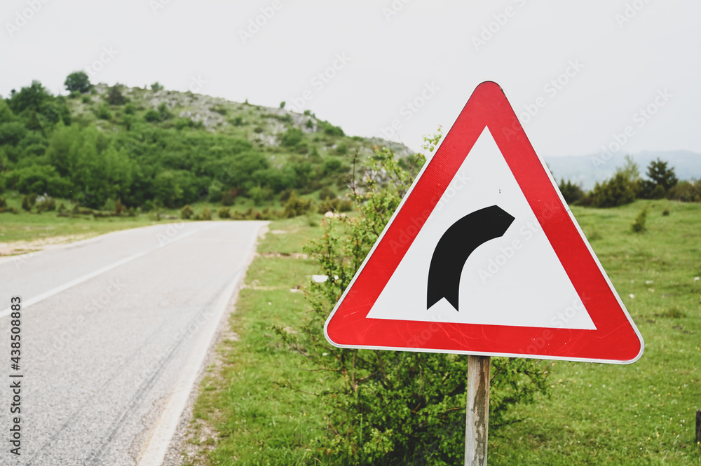 Title: Road sign in countryside. Dangerous curve to the right. Traffic ...