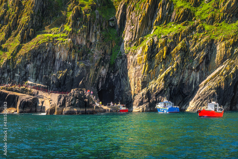 Poster Boats docking to per on Skellig Michael island, tourists on and ...