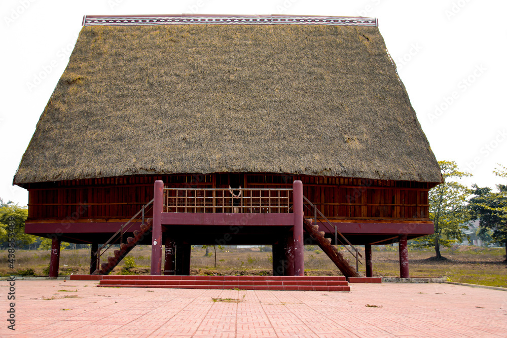 A tourist exploring a traditional architecture of a Bahnar ethnic stilt ...