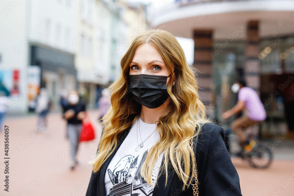 Portrait of young beautiful woman wearing medical mask as protection ...
