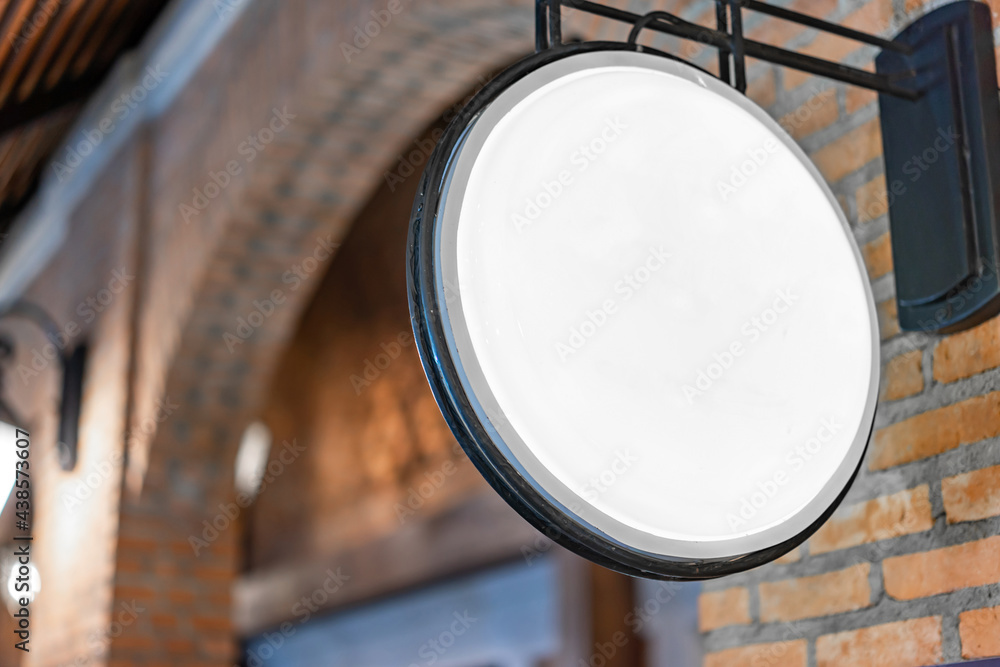 The Circle white Lightbox has hung on the wall in front of the brick ...