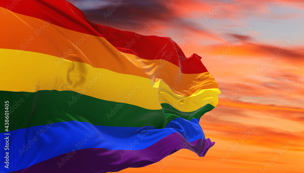 Gay Pride flag waving in the wind at cloudy sky. Freedom and love ...