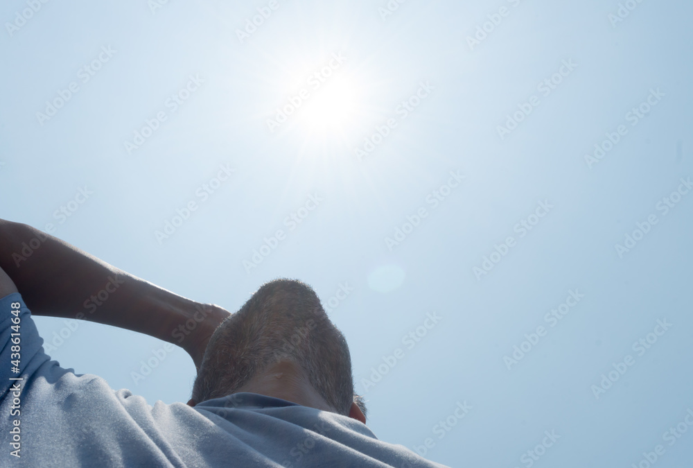 Scorching Hot summer sunlight rays pouring on human head. Hand covering ...