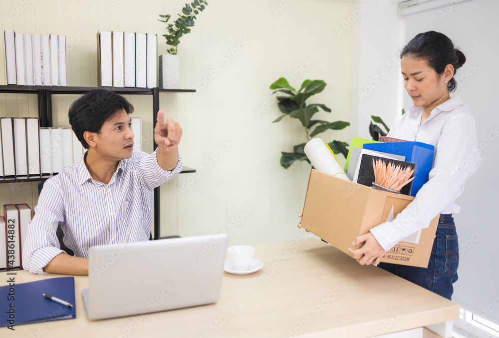 Young man, a power-mad boss, is kicking a young employee from his job ...