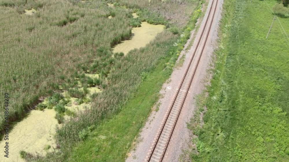 Flying over railway track, top view. Railroad among forest scene in ...