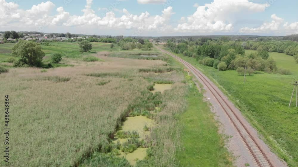 Wetland railroad. Empty single railway around trees and swamp ...