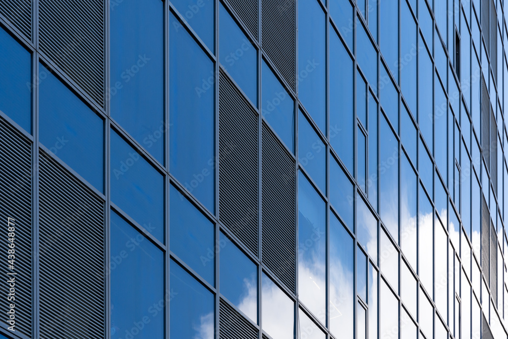 close-up of new skyscrapers with mirrored windows reflecting blue skies ...