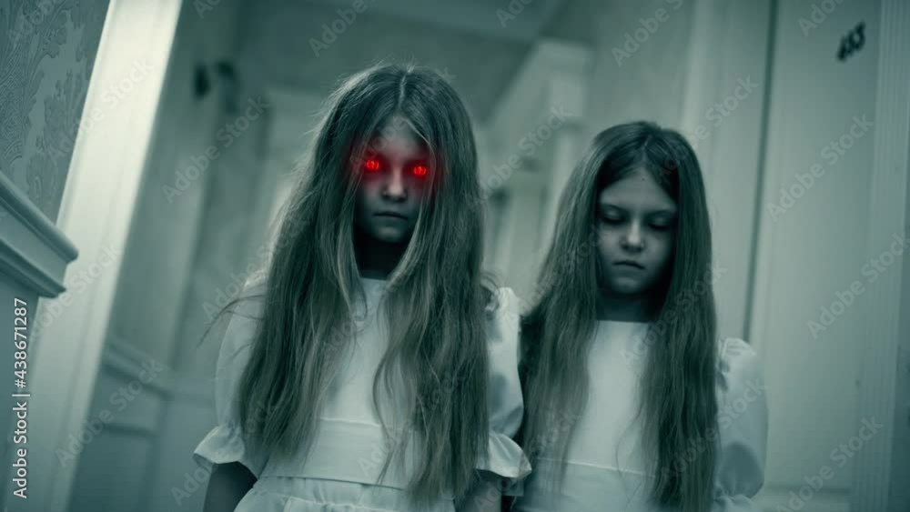 Two creepy little girls with scary evil eyes standing in hotel hall ...