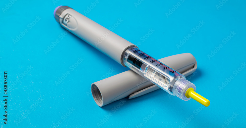 Insulin pen. Insulin pen fill with needle on white background. Diabetes ...