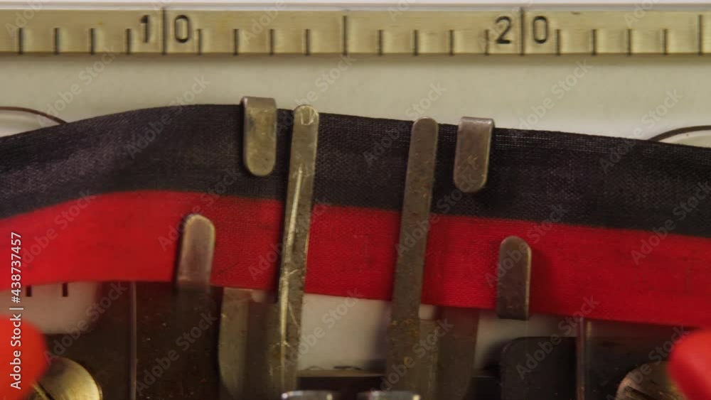 Type red text STOP COVID on stationary mechanical typewriter. English ...