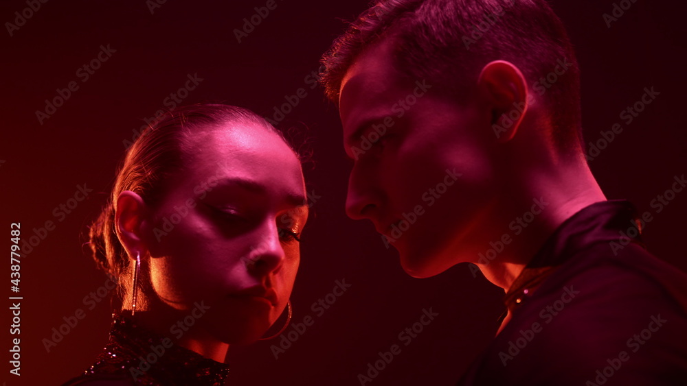 Ballroom dancers looking each other indoors. Dance couple holding hands ...