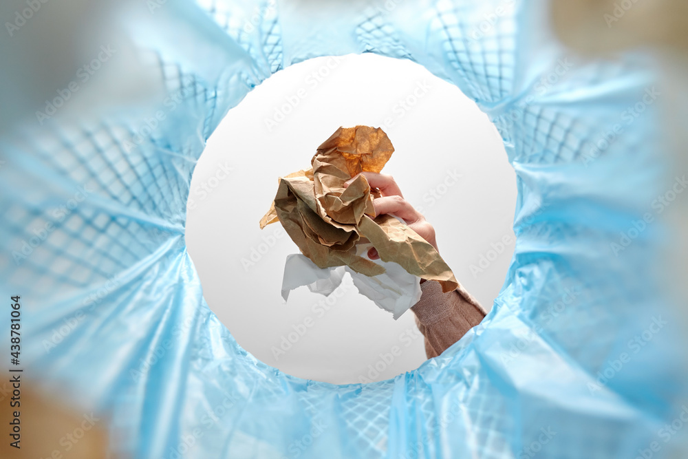 recycling, waste sorting and sustainability concept - hand throwing ...