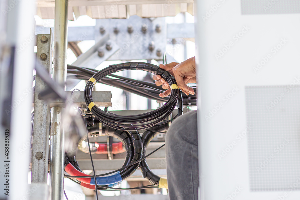 Zdjęcie Stock: Installing a new mobile network cable behind the phone ...