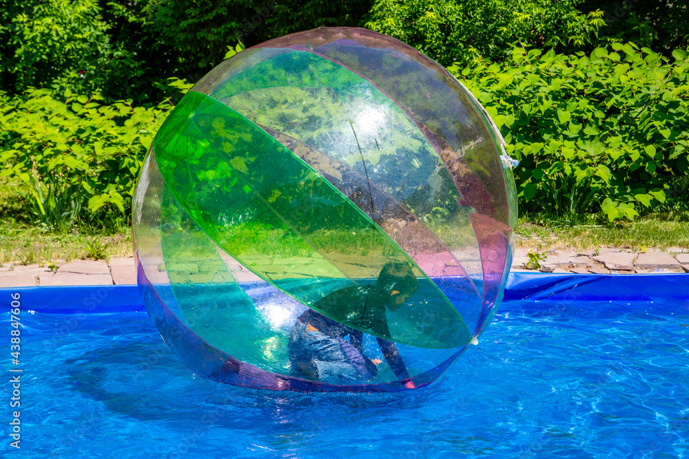 amusement park, a boy rides in an air bubble on the water Stock Photo ...