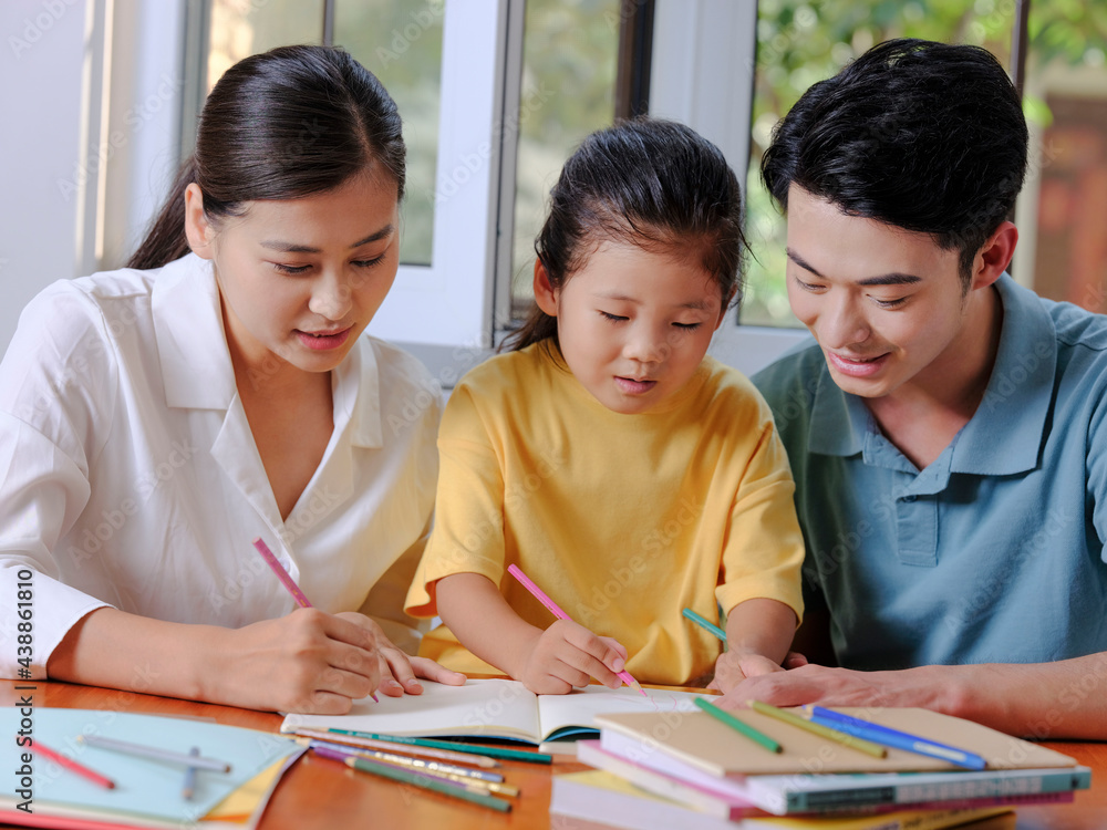 Young parents help their children with their homework Stock Photo ...