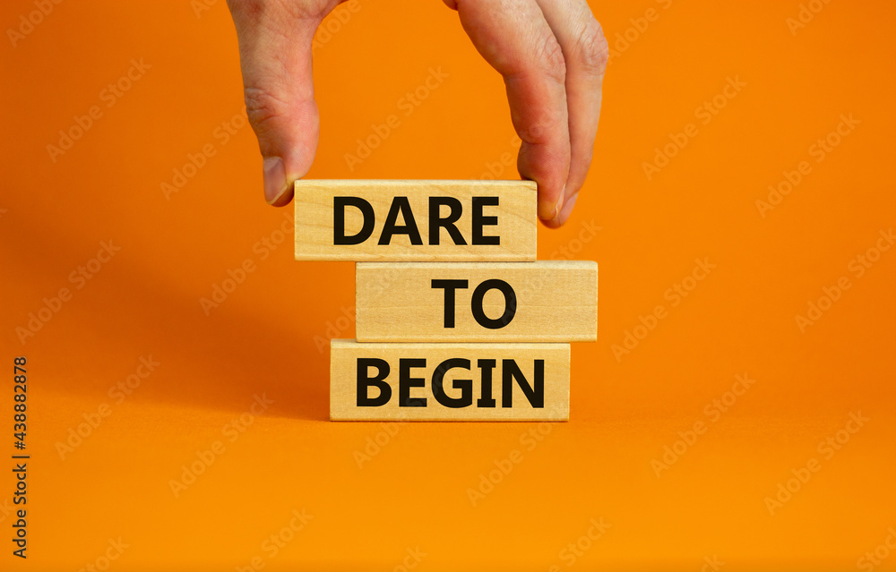 Dare to begin symbol. Wooden blocks with words 'Dare to begin ...
