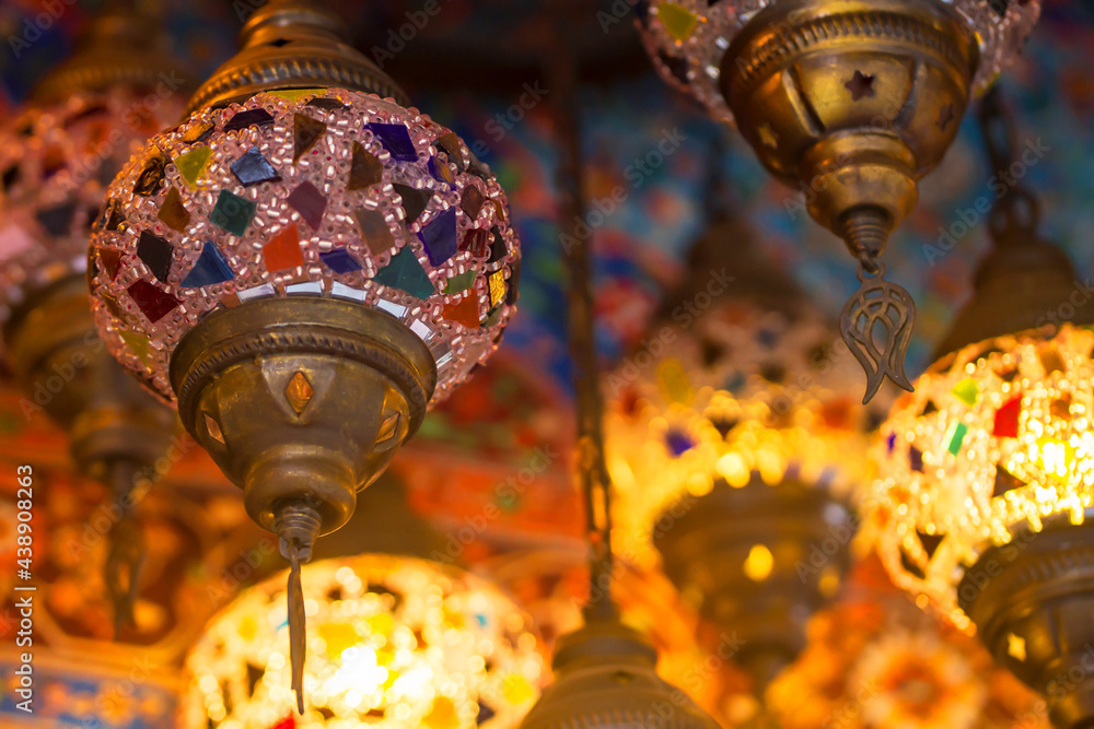 Middle Eastern lambas of different colors and sizes are hanging in the ...