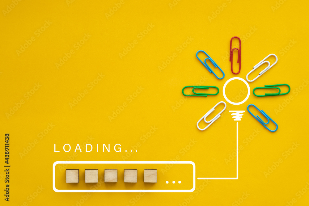 Loading bar almost complete with idea beeing processed on a light bulb on yellow background ...