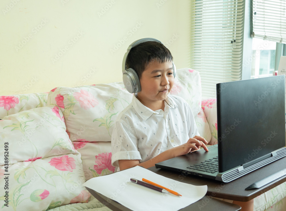 On Asian boy student is learning online class and studying by video ...