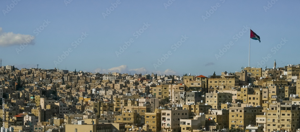 Wide panorama of Amman, the capital city of Jordan, with a Jordanian ...