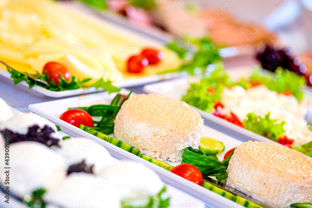 Swedish buffet at the party. Trays with cold snacks, cold cuts, cheeses ...