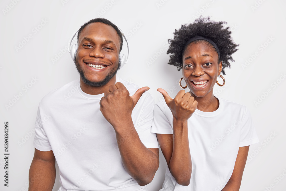 Glad black Afro American girlfriend and boyfriend point at each other ...