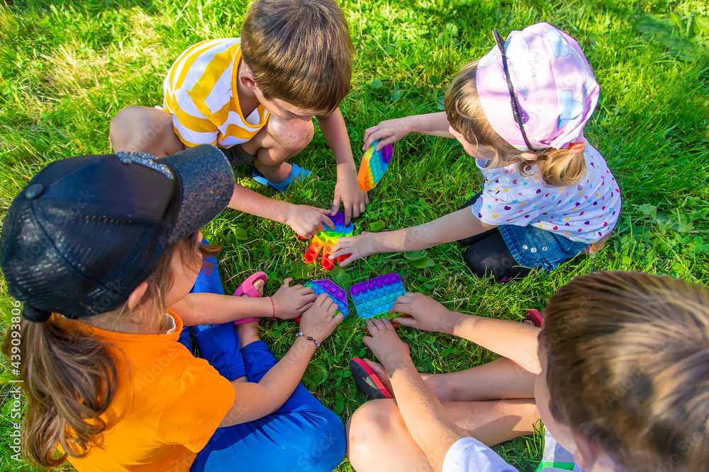 Children play pop it on the street. Selective focus. Stock Photo ...