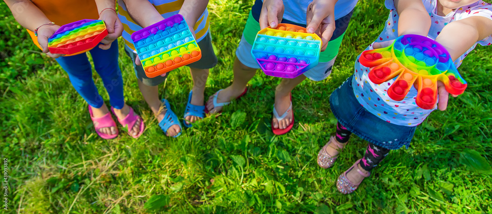 Children play pop it on the street. Selective focus. Stock Photo ...