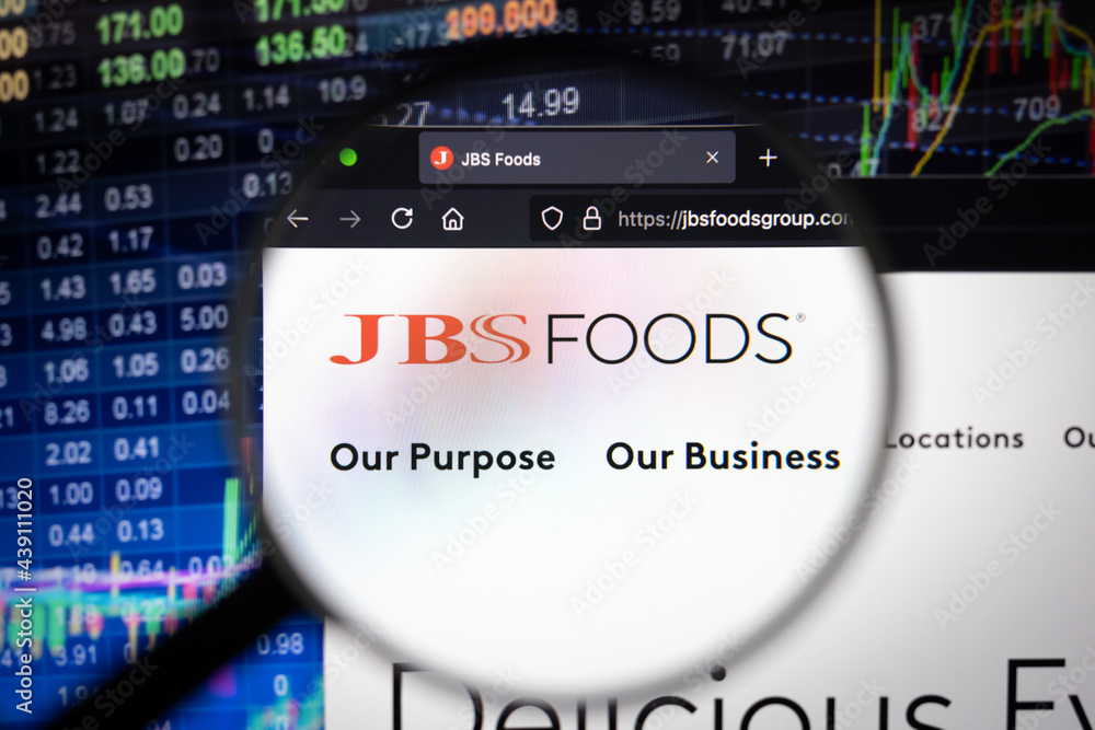 JBS company logo on a website with blurry stock market developments in ...
