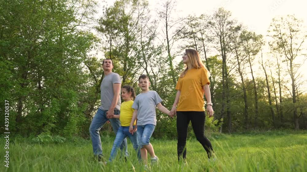 Happy family in park. Group of people walk in field. Parents and ...