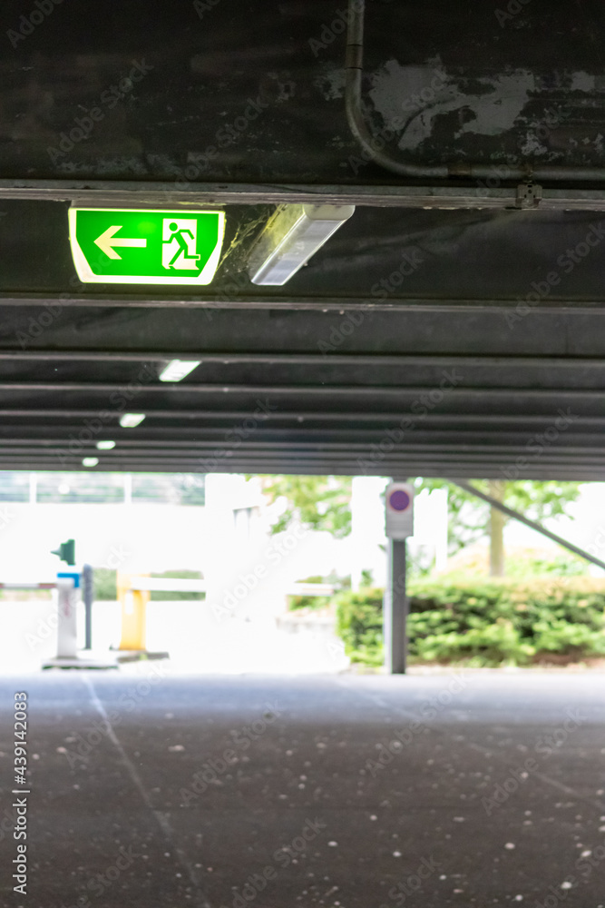 Green exit sign with running person and green arrow shows guidance ...
