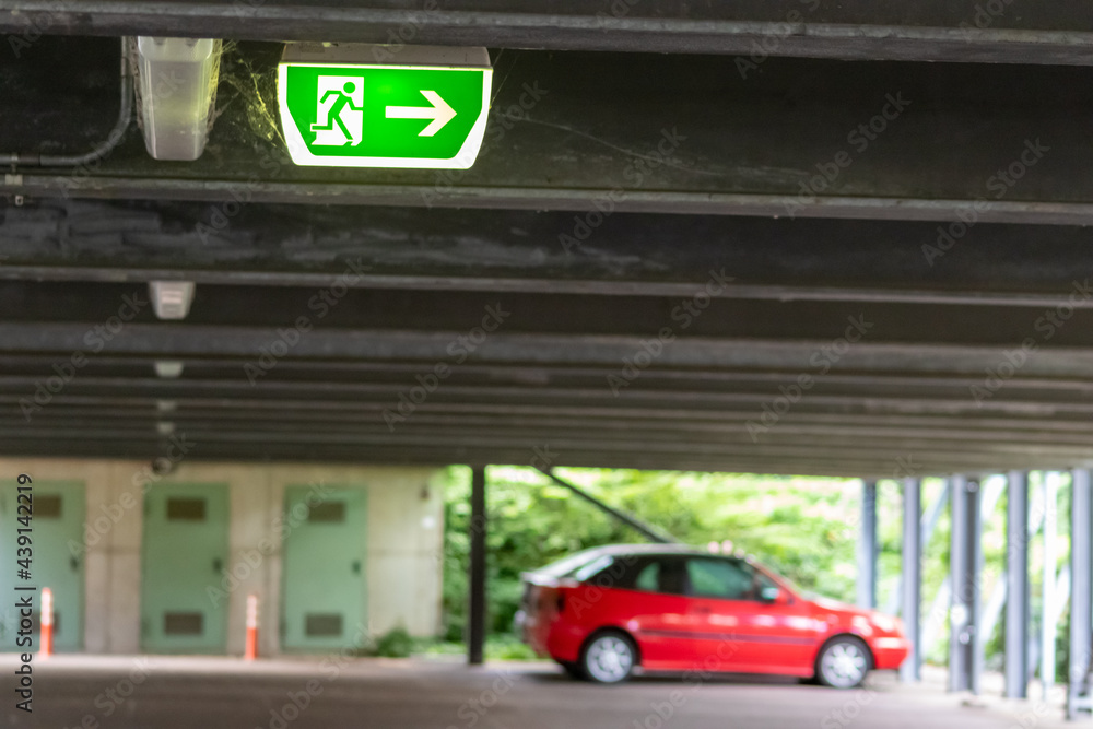 Green exit sign with running person and green arrow shows guidance ...