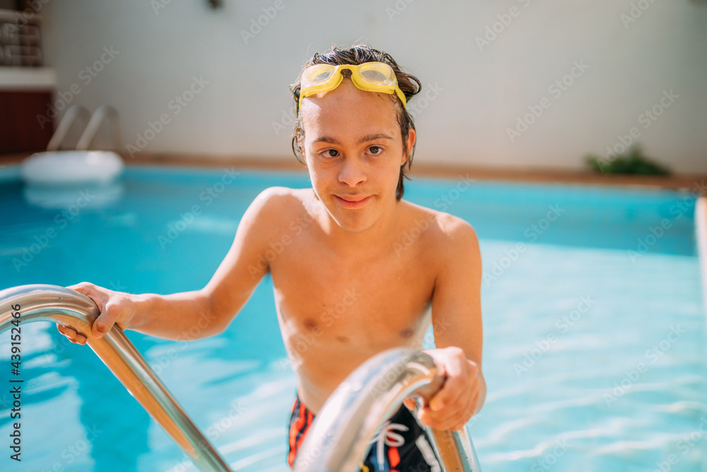 Latino down syndrome boy swimming in the pool. Disabled Brazilian ...