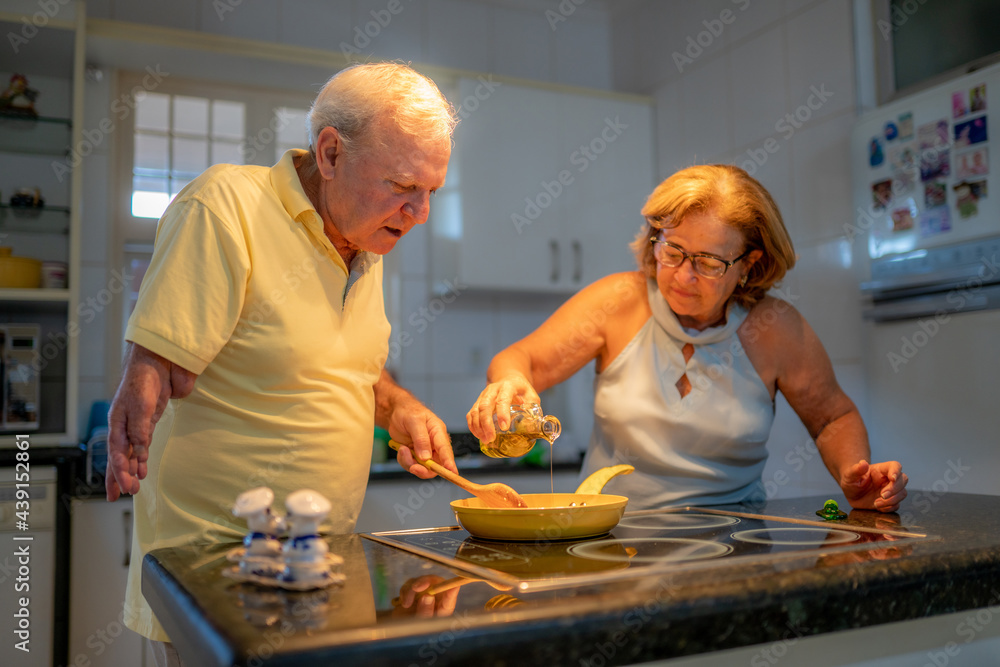 Latin man with amputated arm cooking with his wife. Overcoming the ...